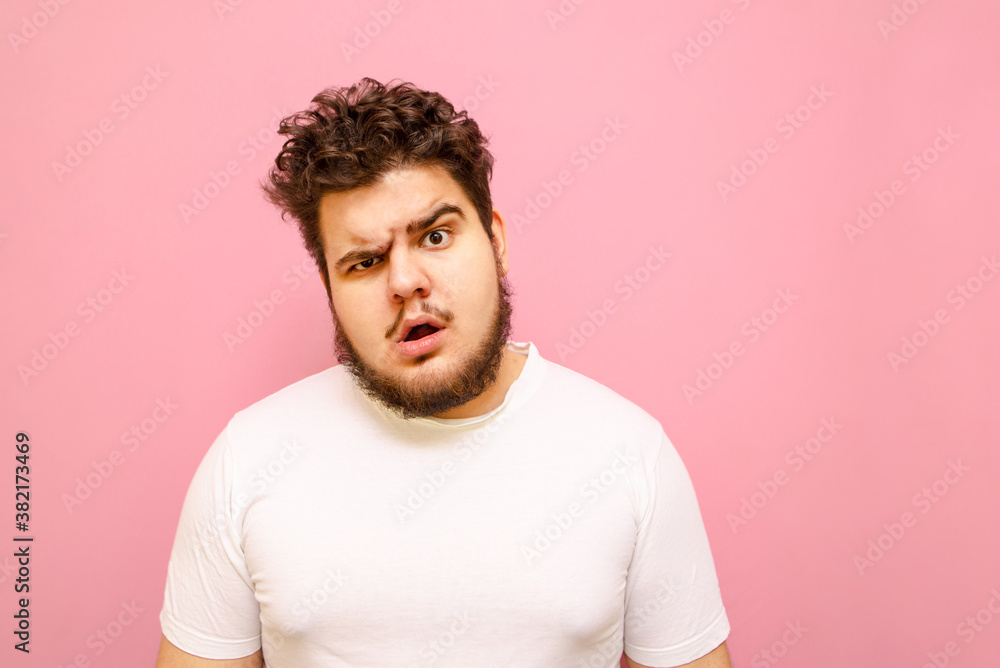 Closeup portrait of a funny surprised fat man with beard and curly hair ...