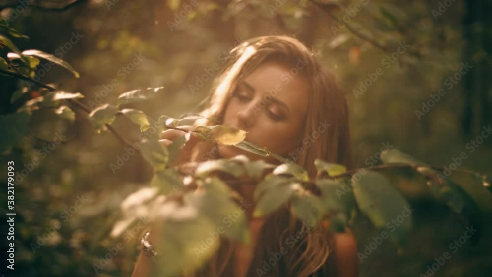 Portrait of a young beautiful model at the green nature forest ...