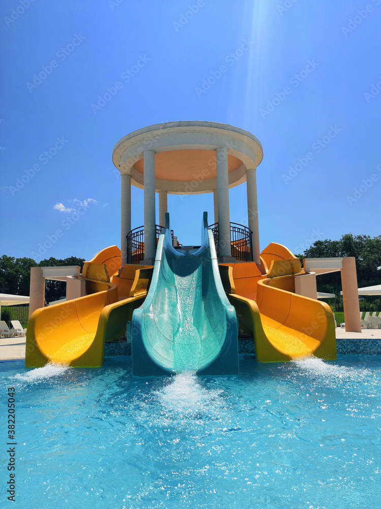 Big striped water slide for extreme descents on an inflatable circle in ...
