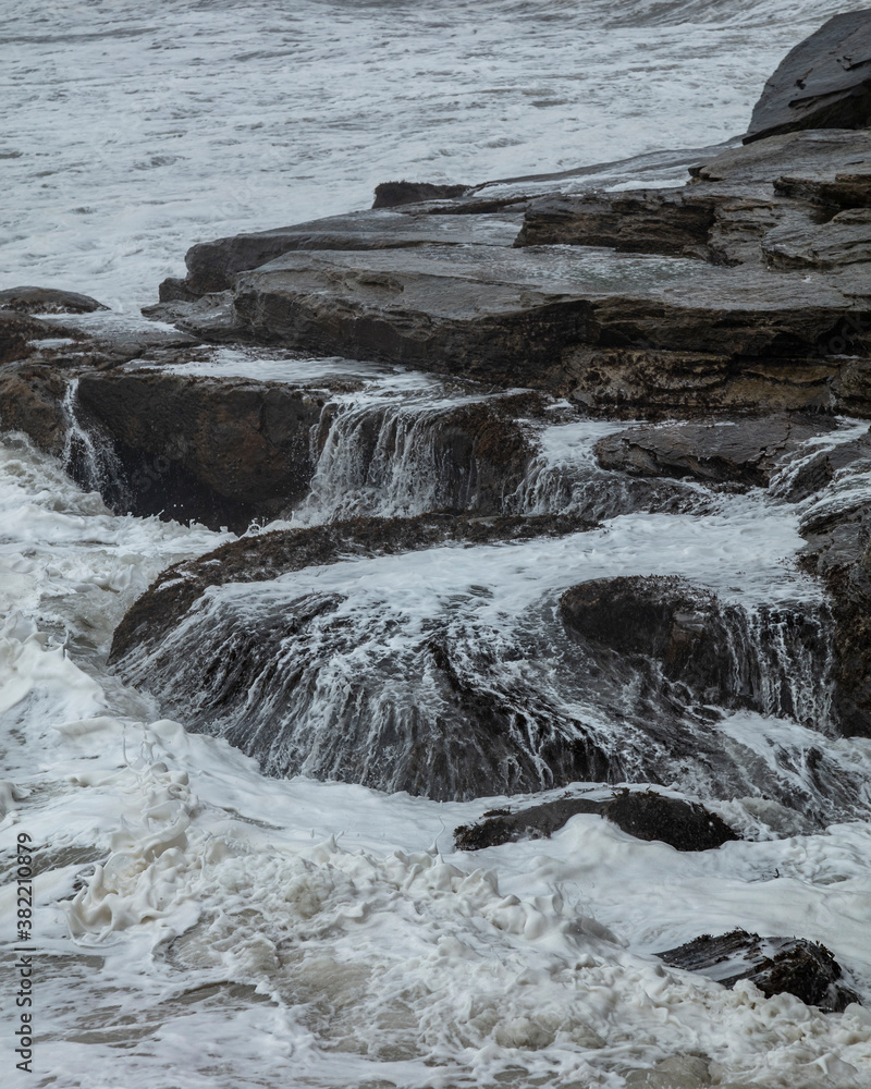Rough, stormy, seas and waves on rock at Seaton Sluice, Northumberland ...