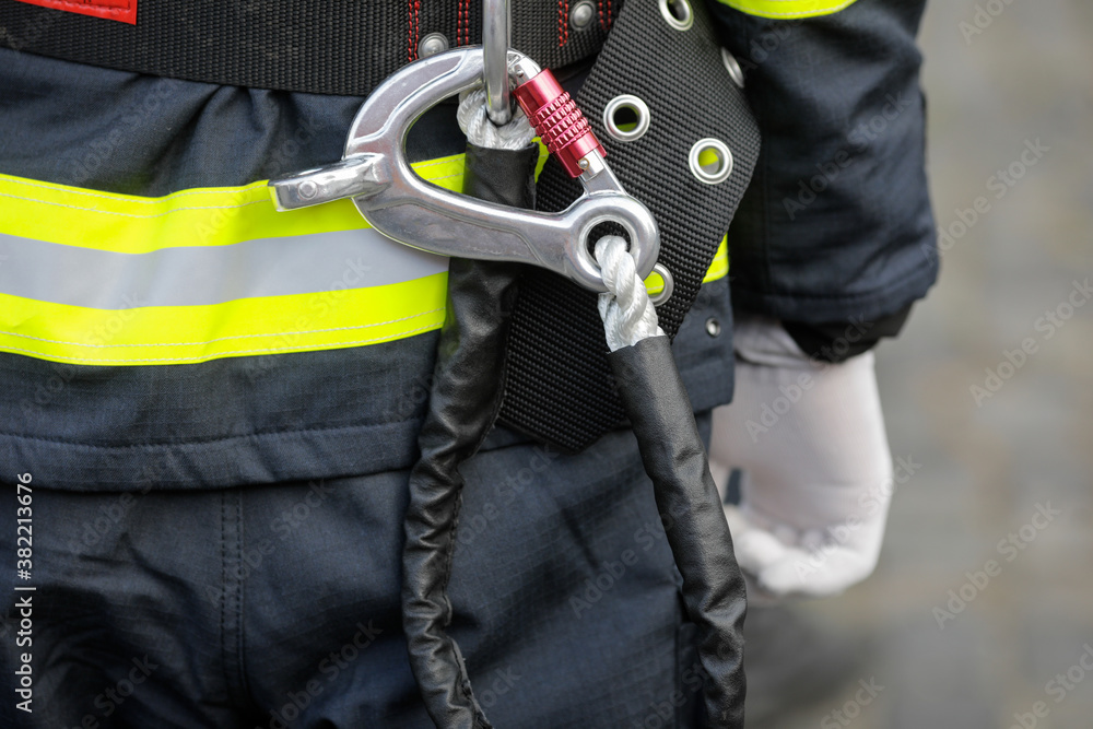 Details with the carabiner and harness of a firefighter. foto de Stock ...