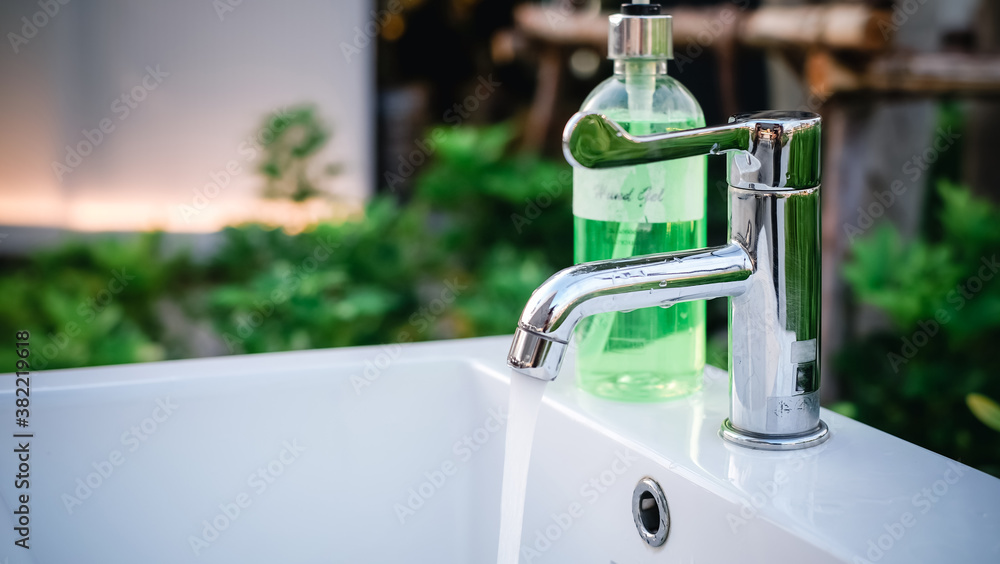 Water flows into the sink and hand gel. Washing hands and cleaning ...
