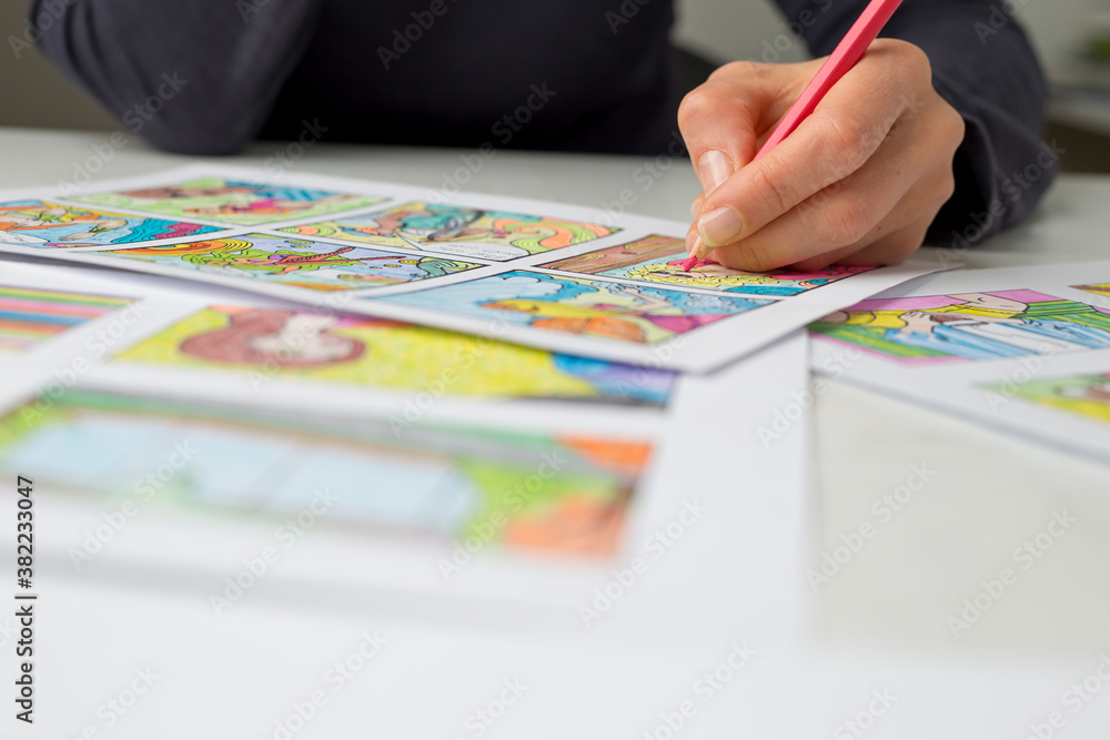 Drawing a colored storyboard. The illustrator creates comics on paper ...