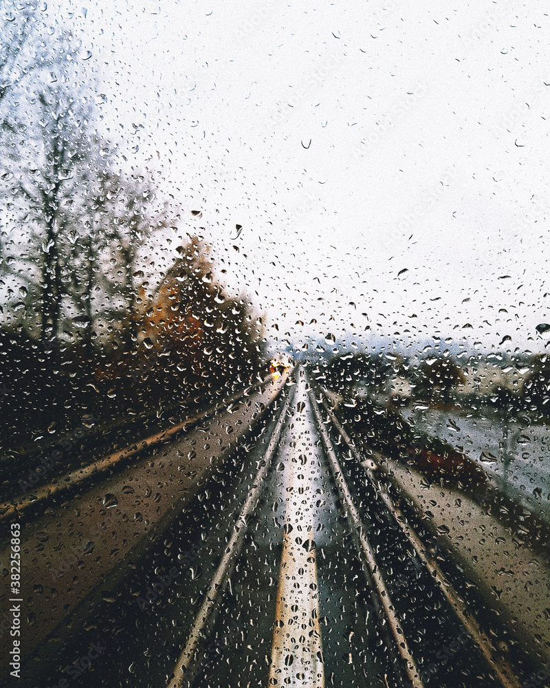 Train tracks as seen through a rain-drenched glass window. Stock Photo ...