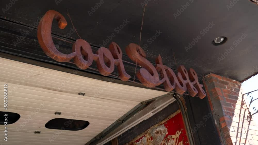 This panning video shows a vintage metal sign that says "cool stuff ...