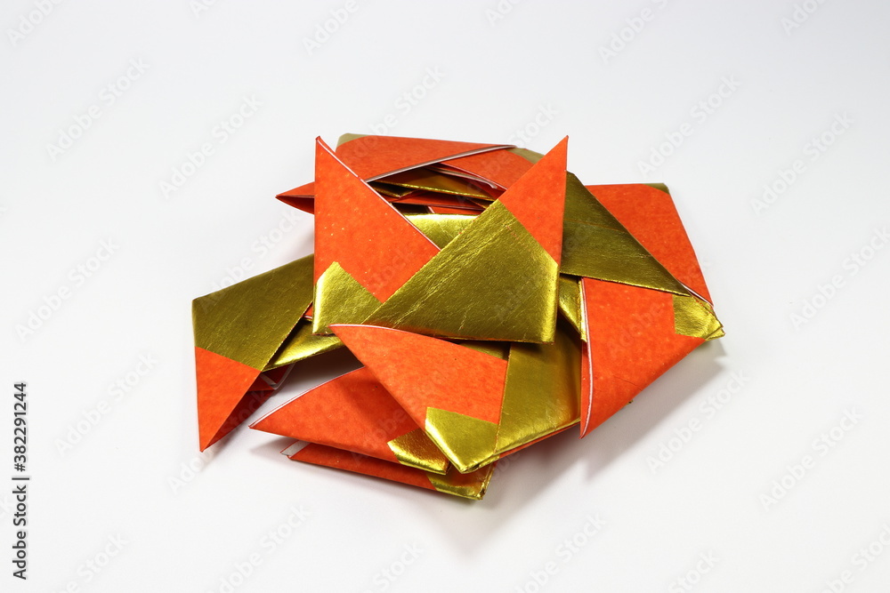 Traditional Chinese gold paper origami isolated on the white background ...