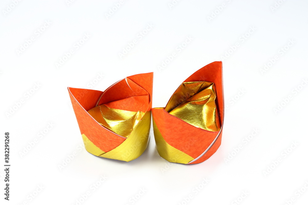 Traditional Chinese gold paper origami isolated on the white background ...