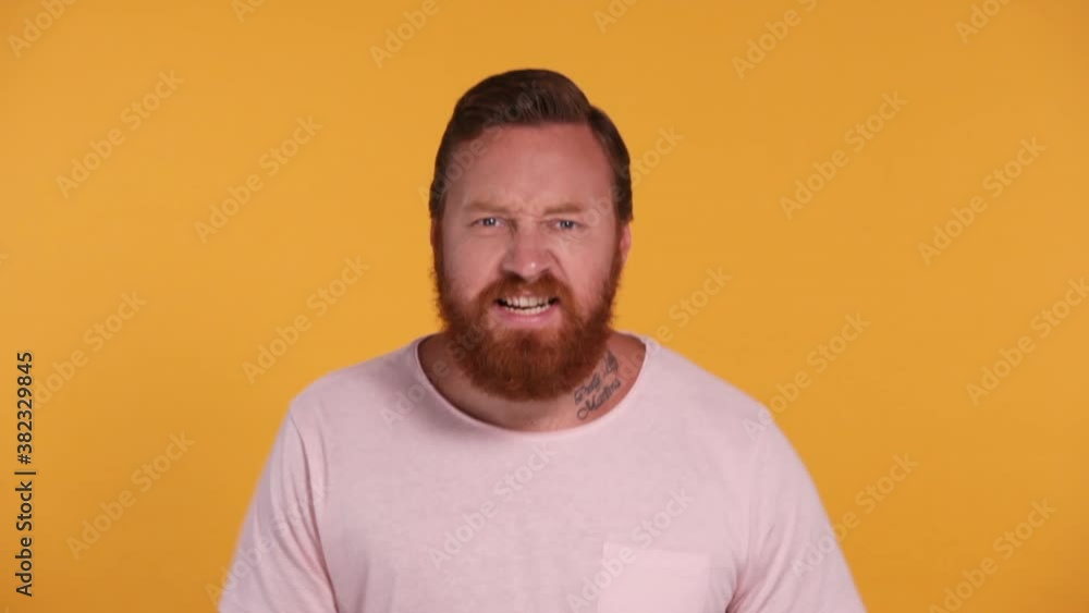 A bearded man warms up, breathing quickly, flexing, clapping himself on ...