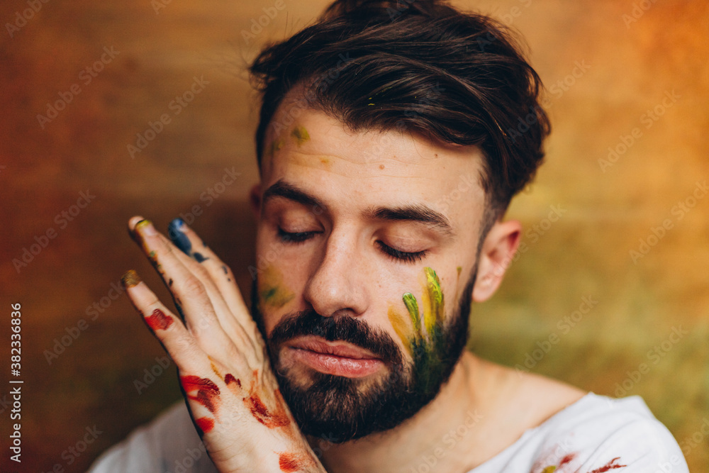 Young creative man who is fond of drawing poses for a photo in his ...