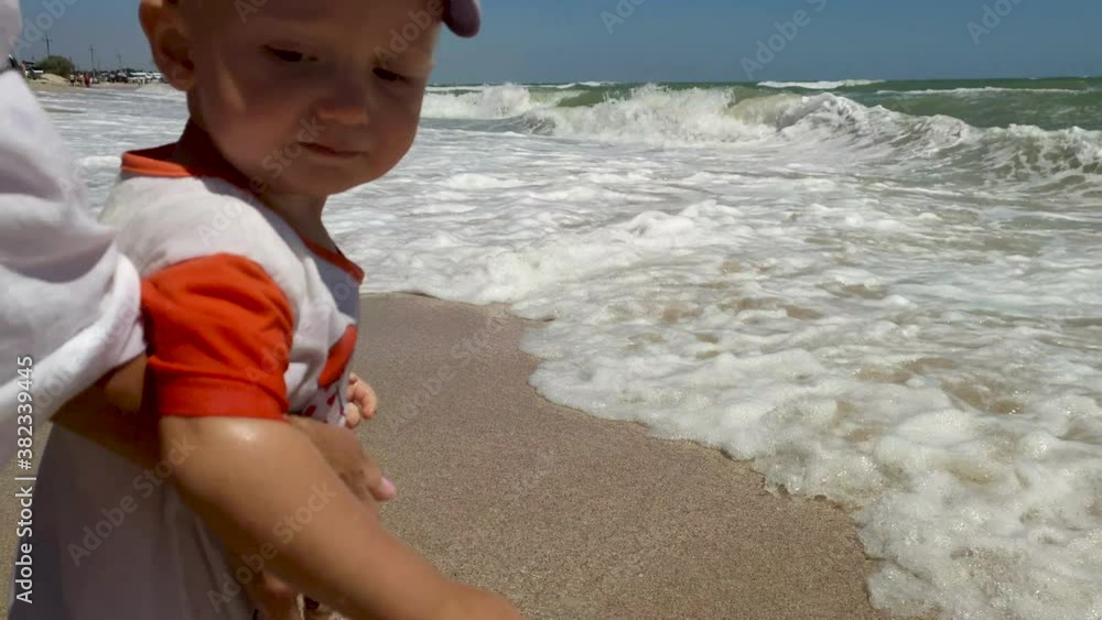 cute little boy happy of sea waves. happy childhood. Boy playing sea ...