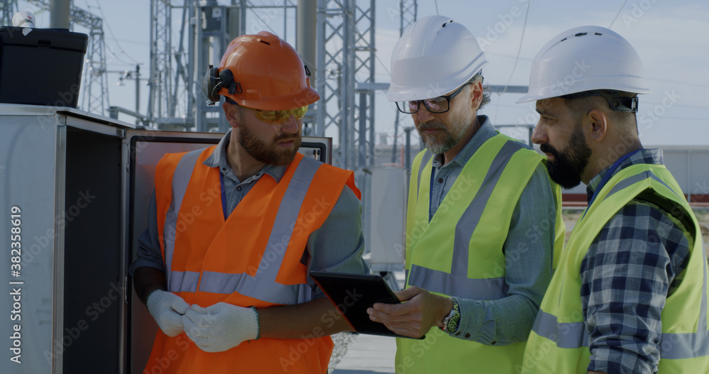 Engineer showing power transformer to inspectors Stock Photo | Adobe Stock