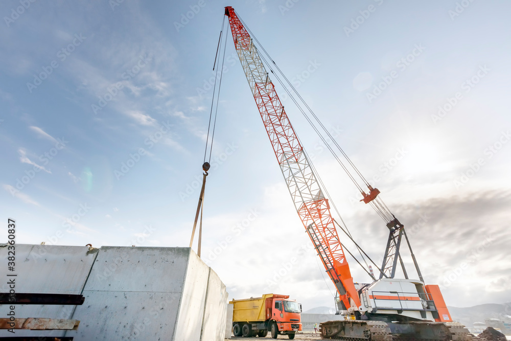 The big crawler crane and other construction machineries are working to ...