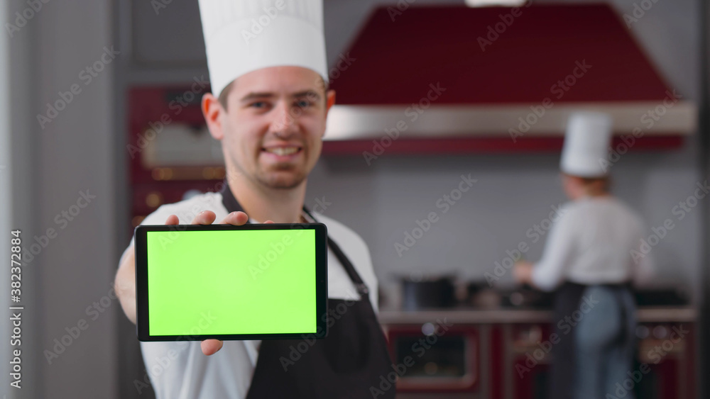 Chef Man Showing Tablet With Green Screen Standing In Restaurant ...