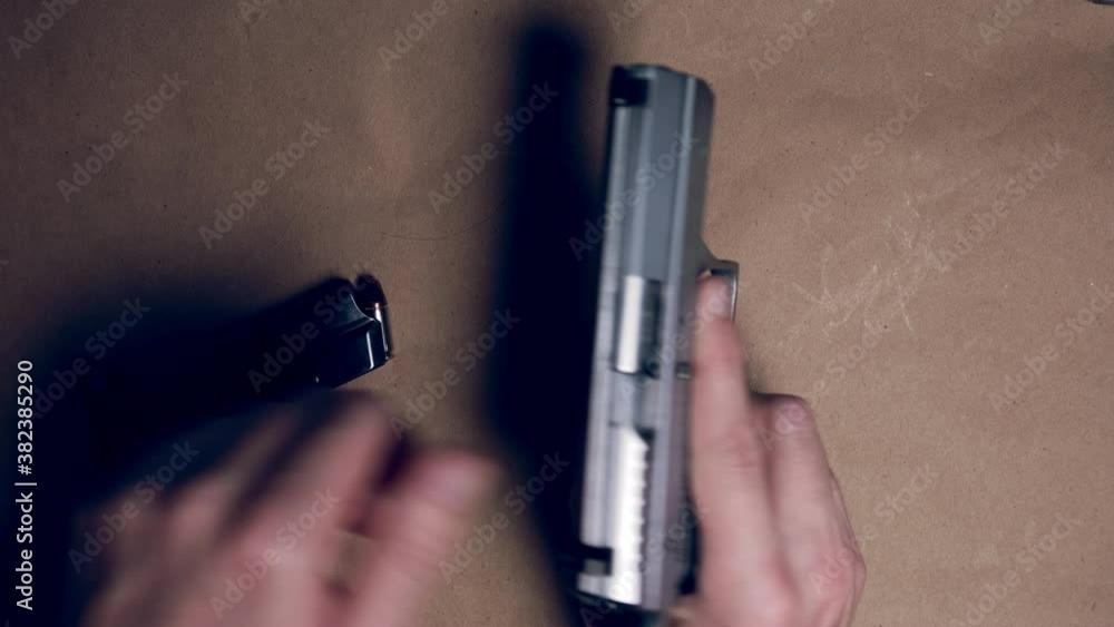Hands unloading 9mm pistol making weapon safe. close up top down Stock ...