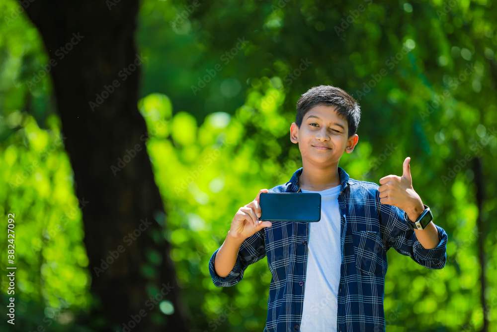 childhood, technology and people concept - indian cute school boy ...