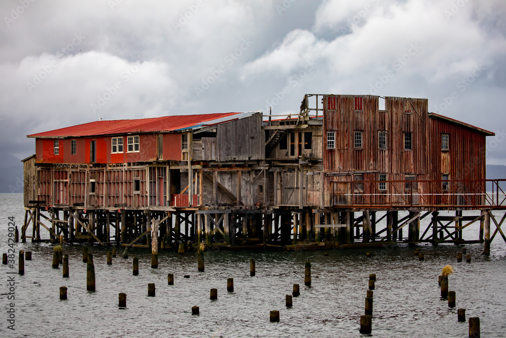 Vintage old and worn abandoned cannery building on Columbia River with ...