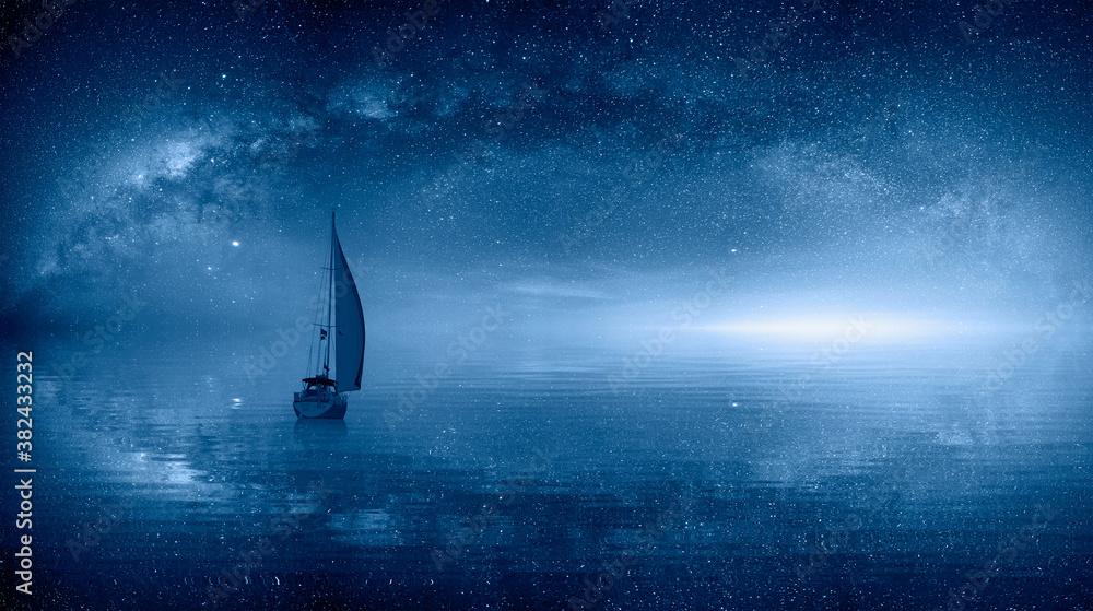 lone sailing luxur yacht under starry night sky with milkyway galaxy ...