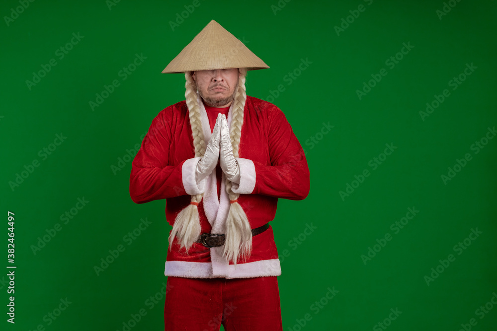 Male actor dressed as Santa Claus with long braids hairstyle and Asian ...