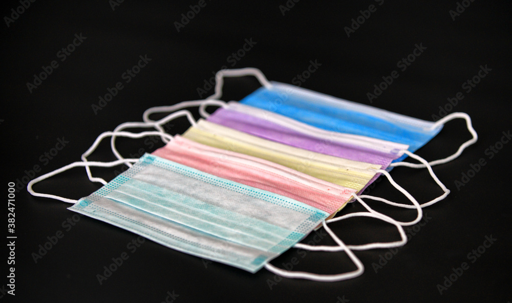 Multi color Medical face protection mask arange on black background ...