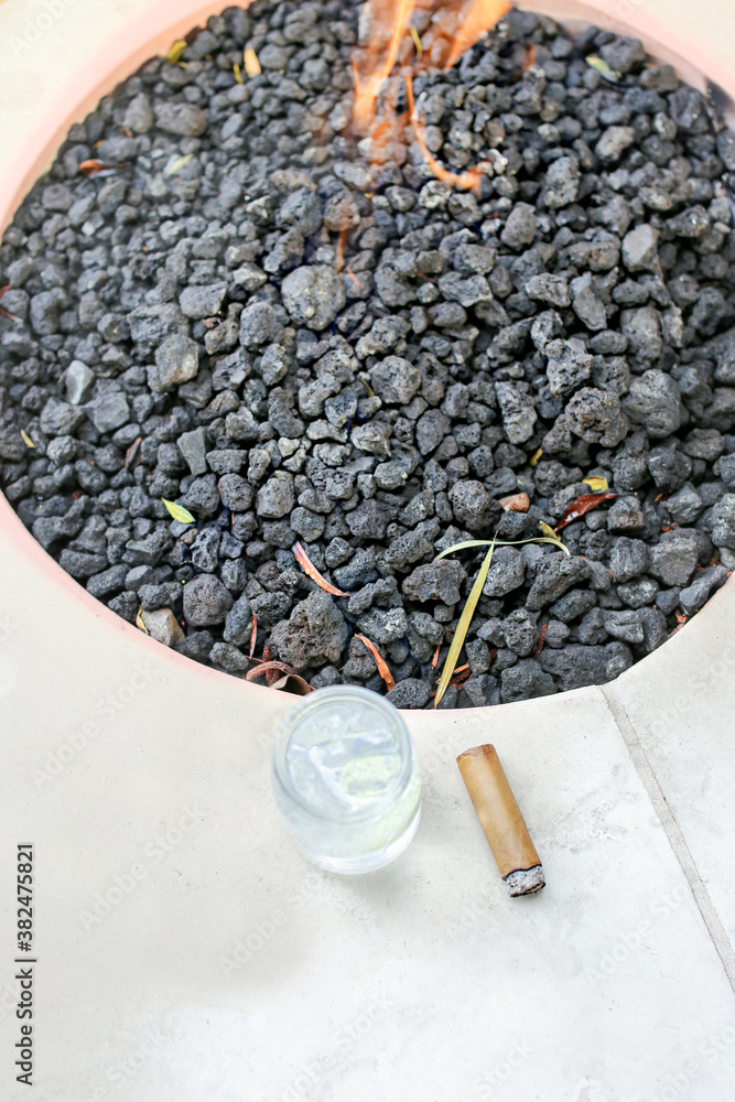 Cigar and a cocktail by an outdoor fire pit Stock-Foto | Adobe Stock