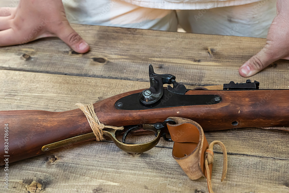Poster old muzzle-loading weapon, trigger traditional musket on a ...
