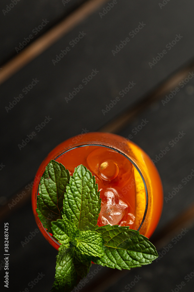 Aperol spritz cocktail in big wine glass with bloody oranges decorated ...