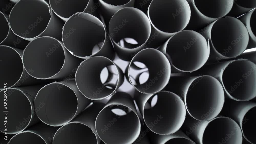 Empty toilet paper rolls on black background. Pyramid of hygiene items ...