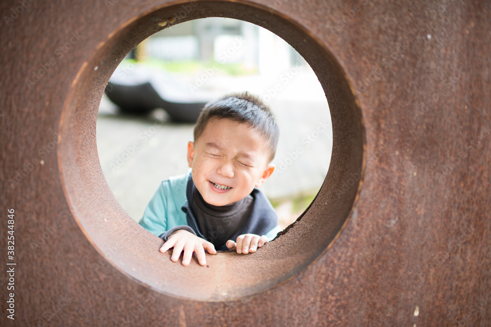 Boy Looking Through Circular Architectural Design Feature in Wall Stock ...