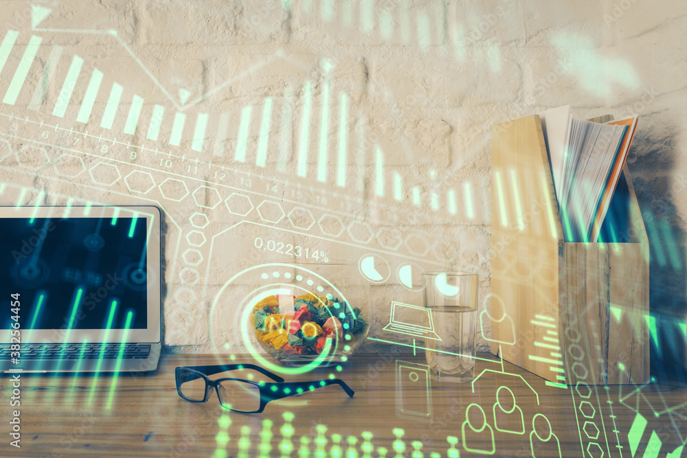 Computer on desktop in office with technology theme hologram. Double ...