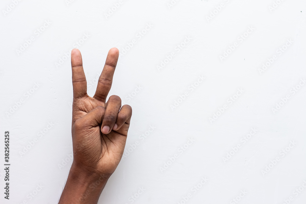 Boy hand showing number two gesture symbol isolated on white background ...