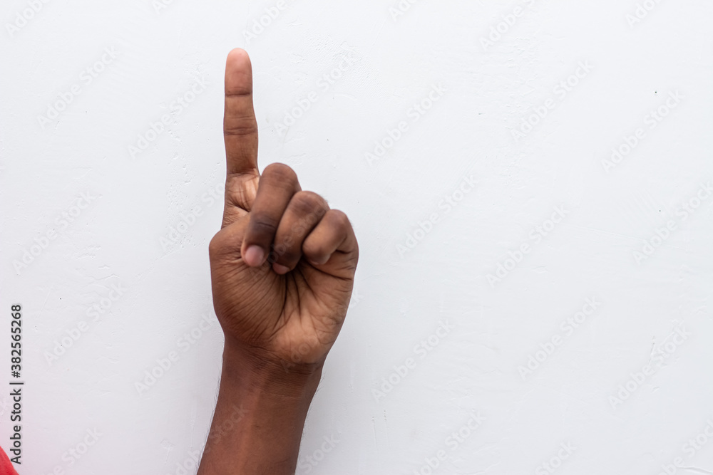 Boy hand showing number one gesture symbol isolated on white background ...