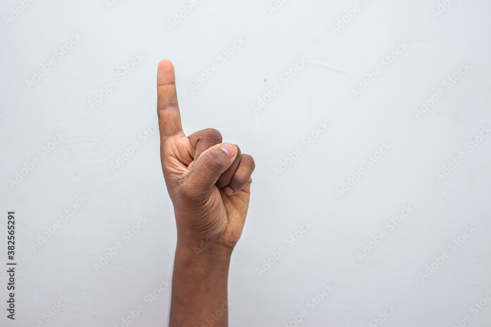 Boy hand showing number one gesture symbol isolated on white background ...