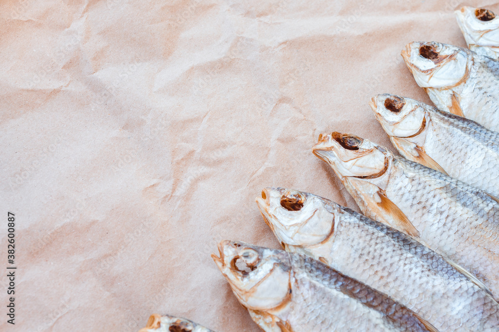 Dried fishes flat lay template banner on craft paper background with ...