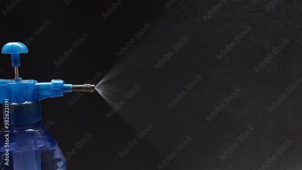 Using spraying bottle and cleaning on black background. foggy pump ...