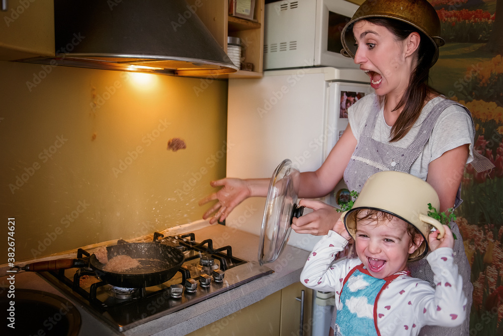Mother and daughter are frying cutlets like crazy in the kitchen. Fun ...