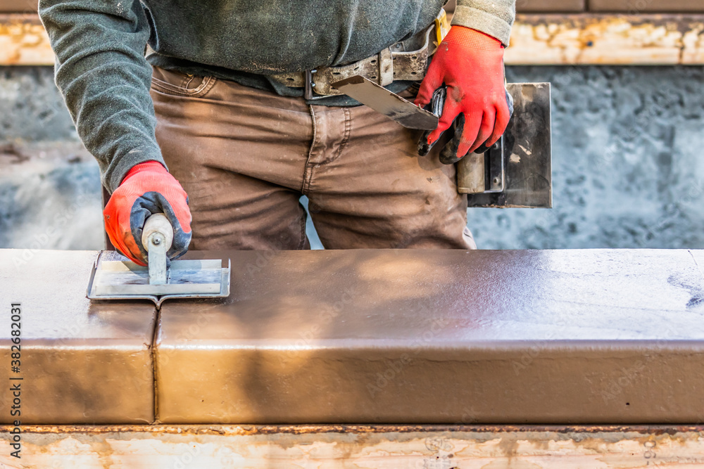 Construction Worker Using Hand Groover On Wet Cement Forming Coping ...