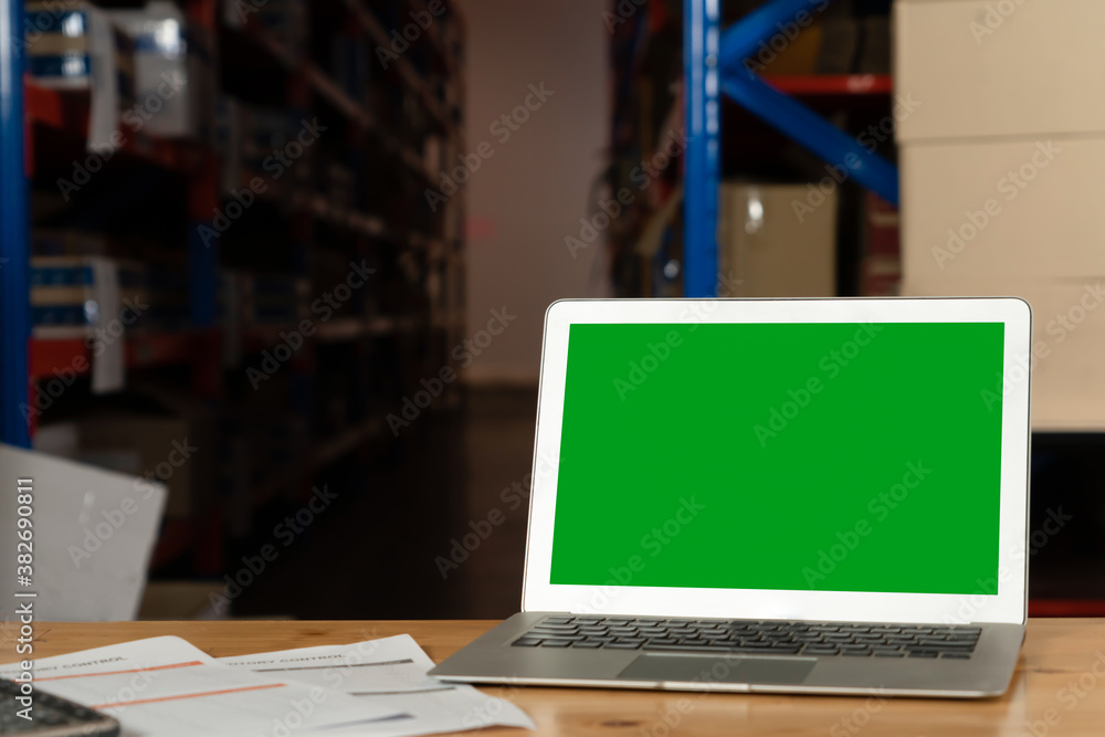 Computer with green screen display in warehouse storage room . Delivery ...