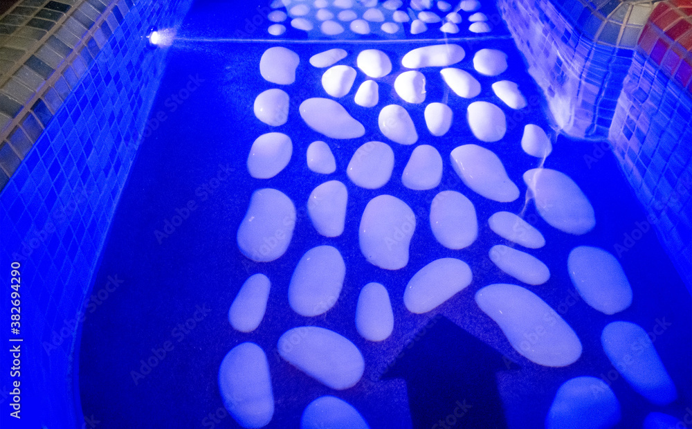 A relaxing aromatic foot bath with massaging white stone pebble bed ...