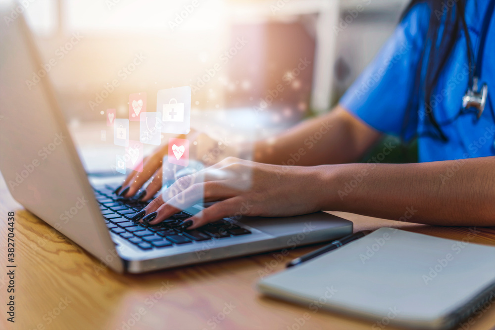 Female doctor using a computer laptop working using modern technology ...