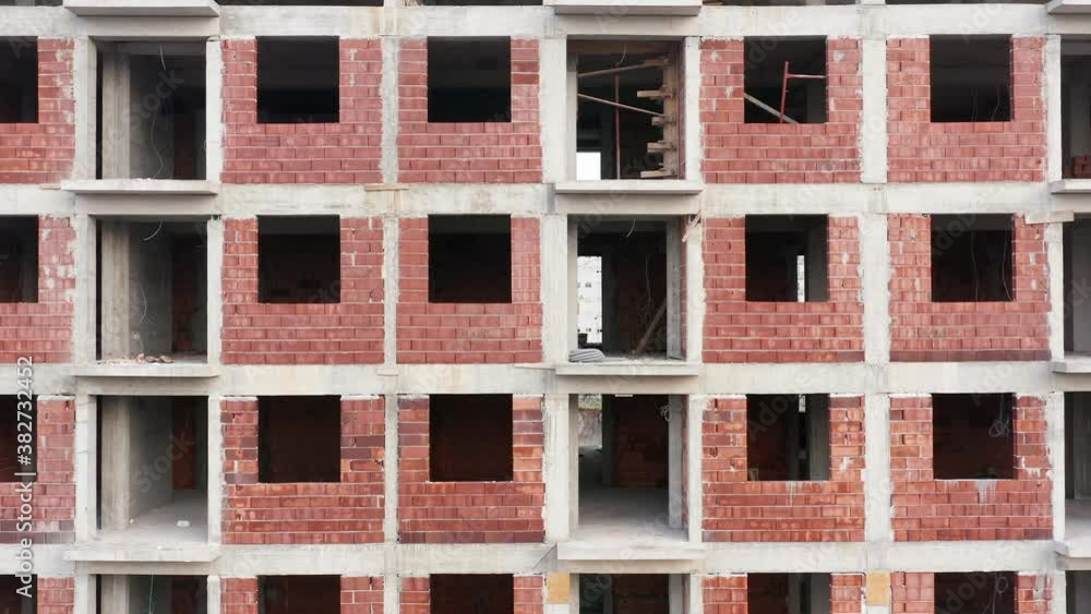 Exterior, non load bearing, red brick walls on a reinforced cement ...