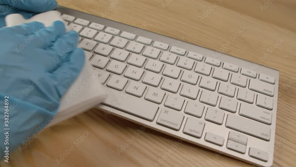 Cleaning the desktop keyboard in the office, maintaining hygiene ...