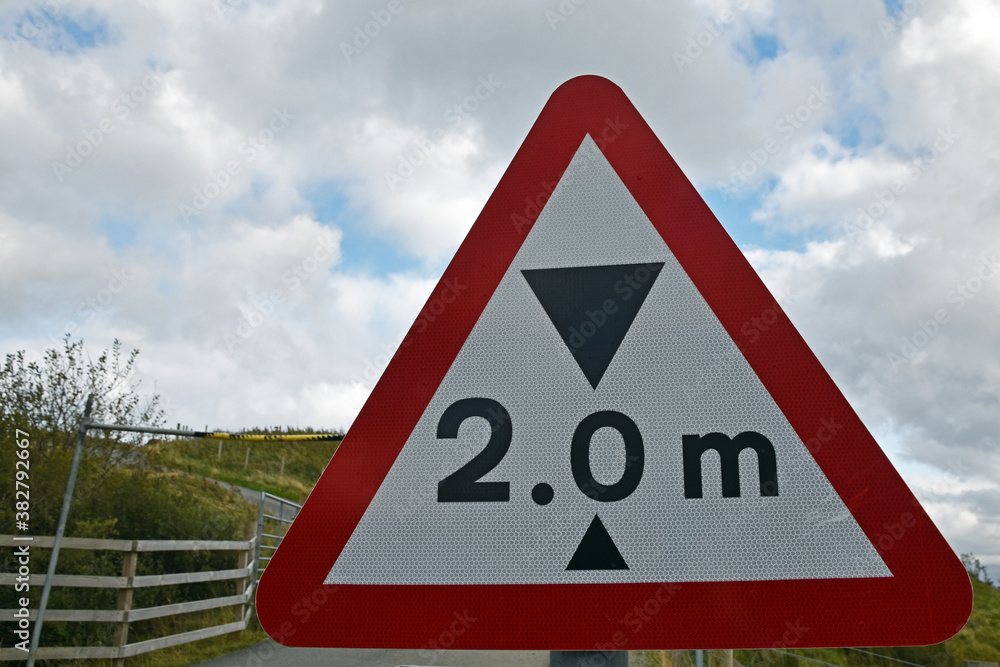 Isolated red, white and black triangular warning sign indicating height ...