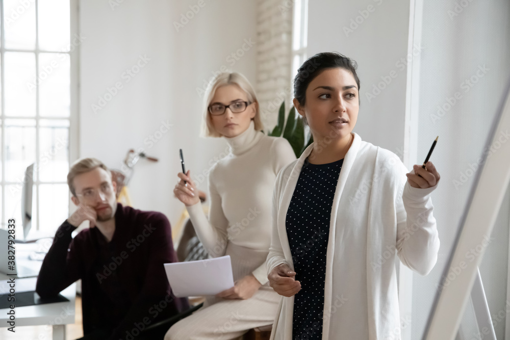 Focused young indian female coach or trainer present company business ...
