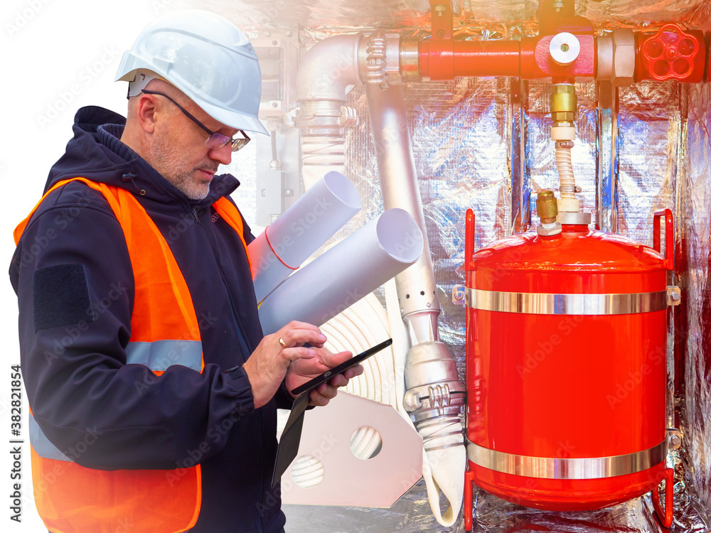 Fire safety. Checking fire-fighting equipment. A safety engineer checks ...
