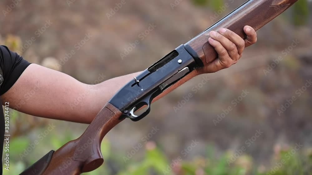 Close up of a hunter hands unloading a shotgun. Slow motion. High ...