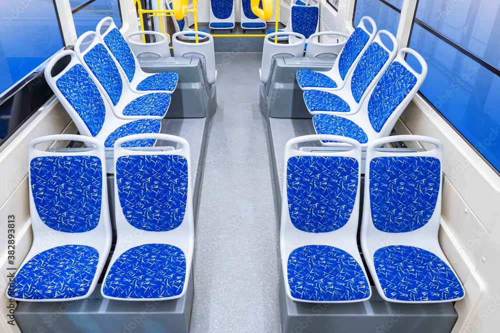 Empty interior of the city bus. Blue passenger seats on the bus. Urban ...