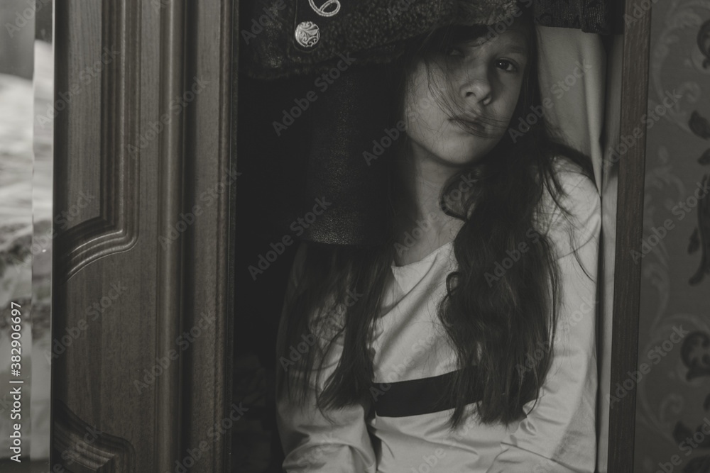 Child scared of nightmare and hiding in closet. Ghost of little girl ...
