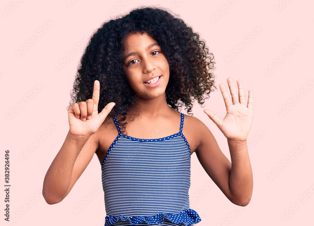 African american child with curly hair wearing swimwear showing and ...