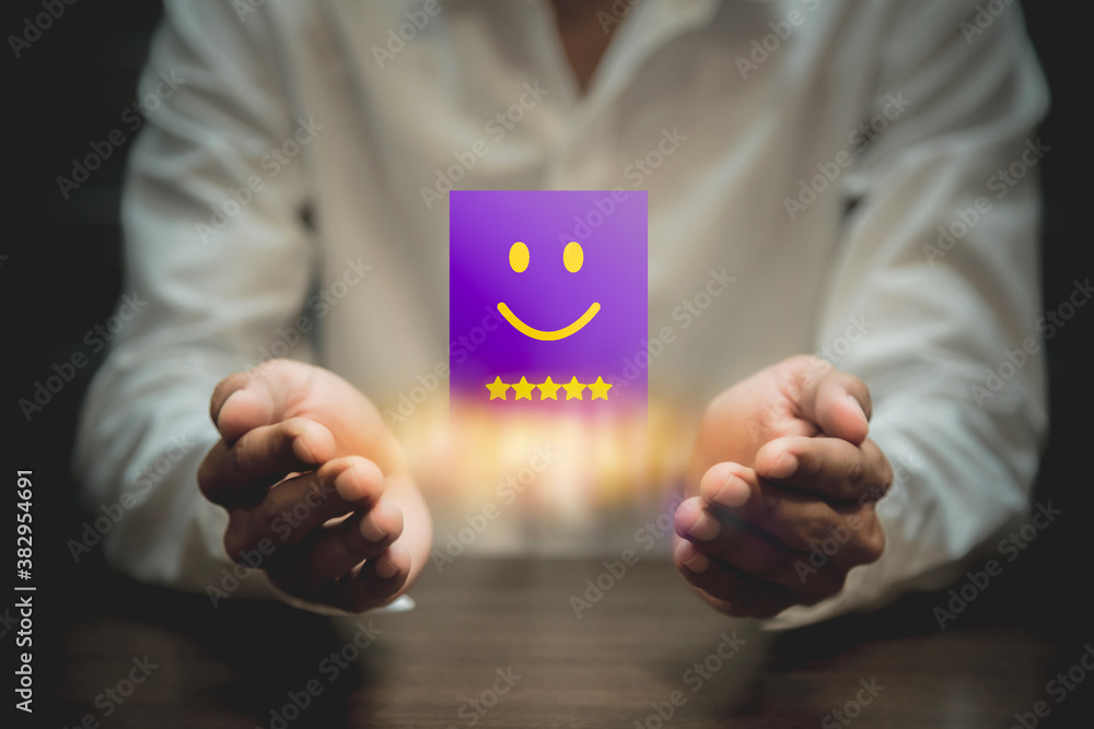 Businessman pressing smiley face emoticon on virtual touch screen ...