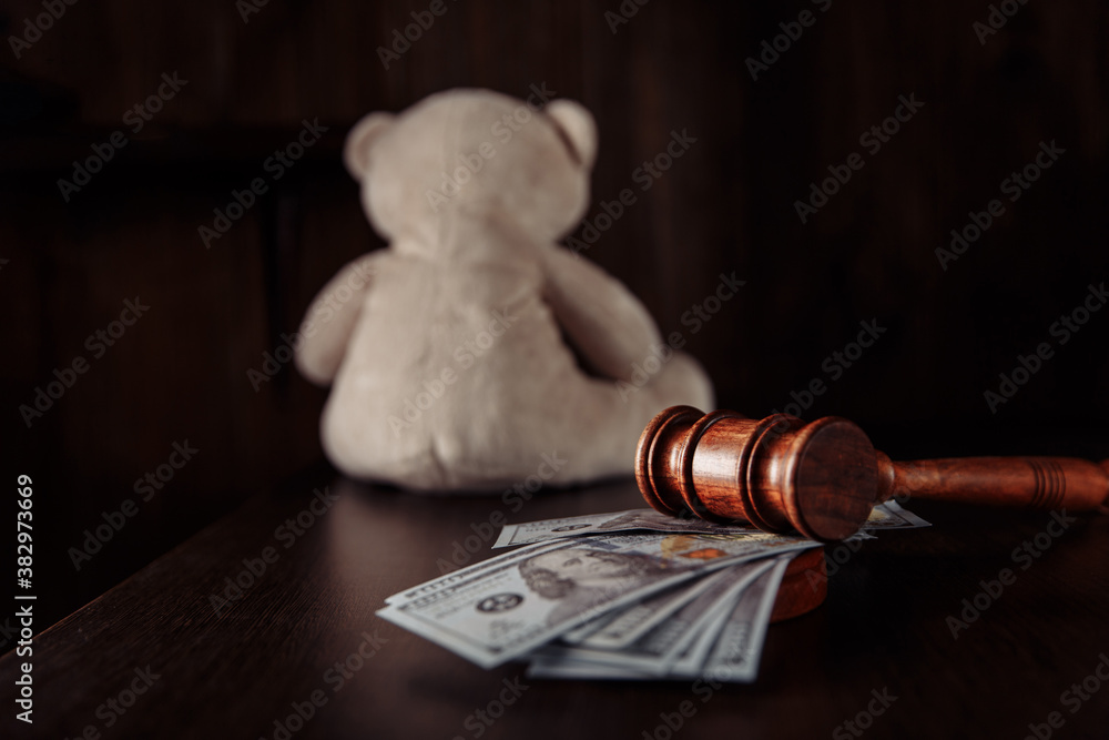 Judge gavel, dollar banknotes and teddy bear as a symbol child's rights ...